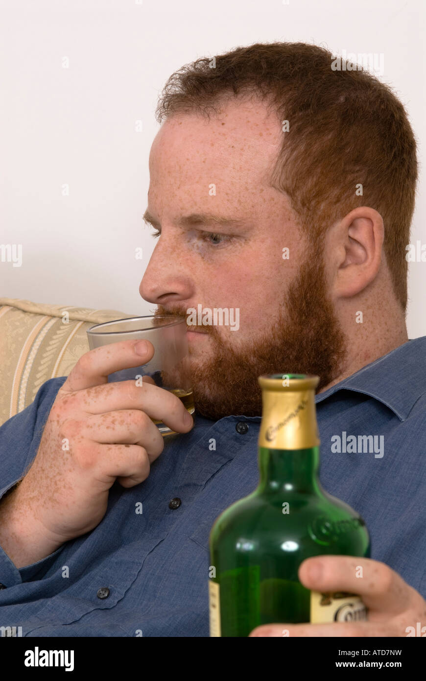 depressed tired alcoholic young man drinking whisky alcohol spirits ...