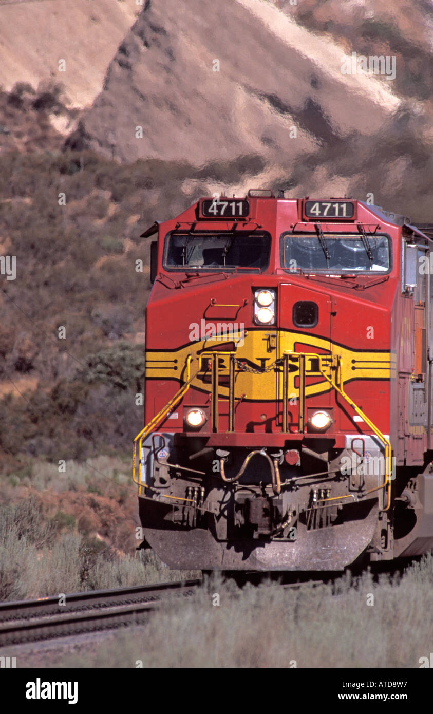 BNSF locomotive number 4711 at the head of a shipping container train ...