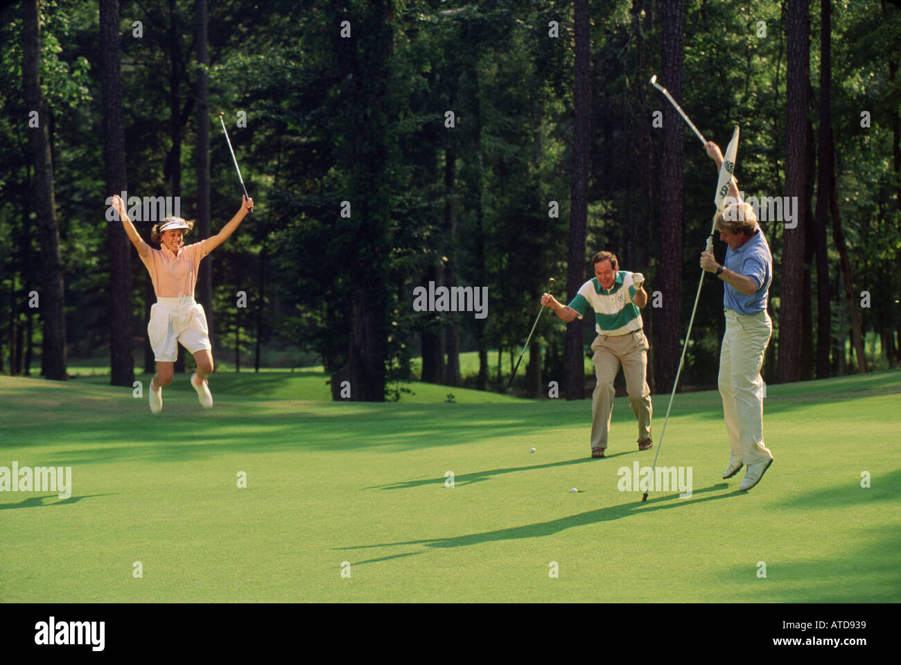 A female golfer jumps for joy as she sinks a putt Stock Photo - Alamy
