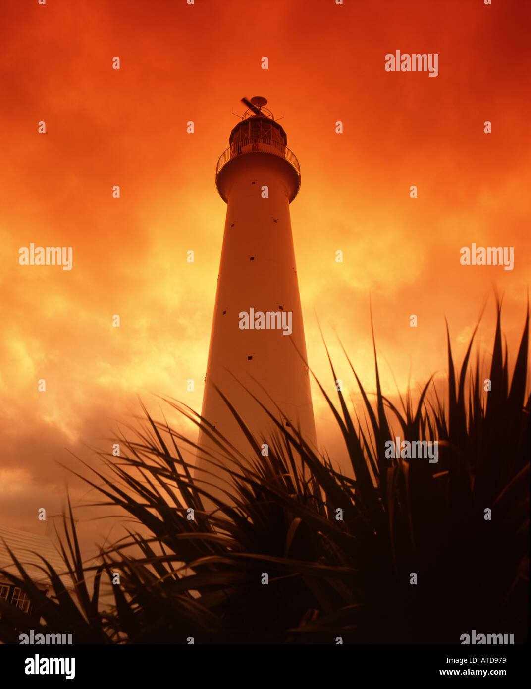 Gibbs Hill Lighthouse against a fiery orange sky at sunset Bermuda ...