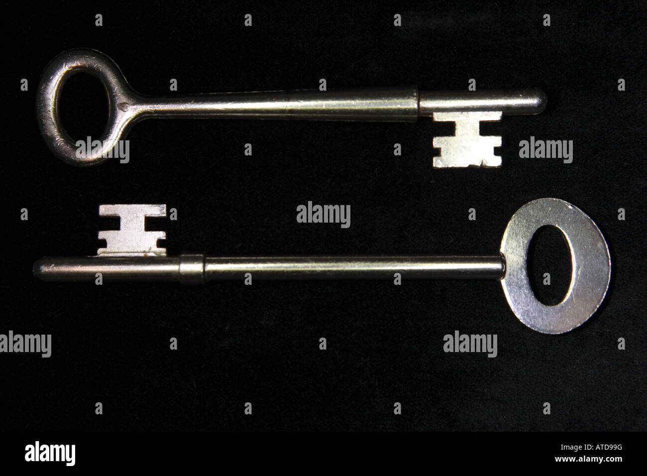 Two steel keys on black background Stock Photo - Alamy