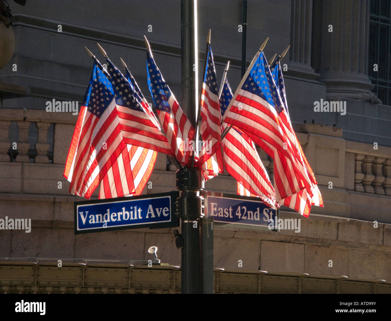 American flags on display on a street sign on 42nd Street in New York ...