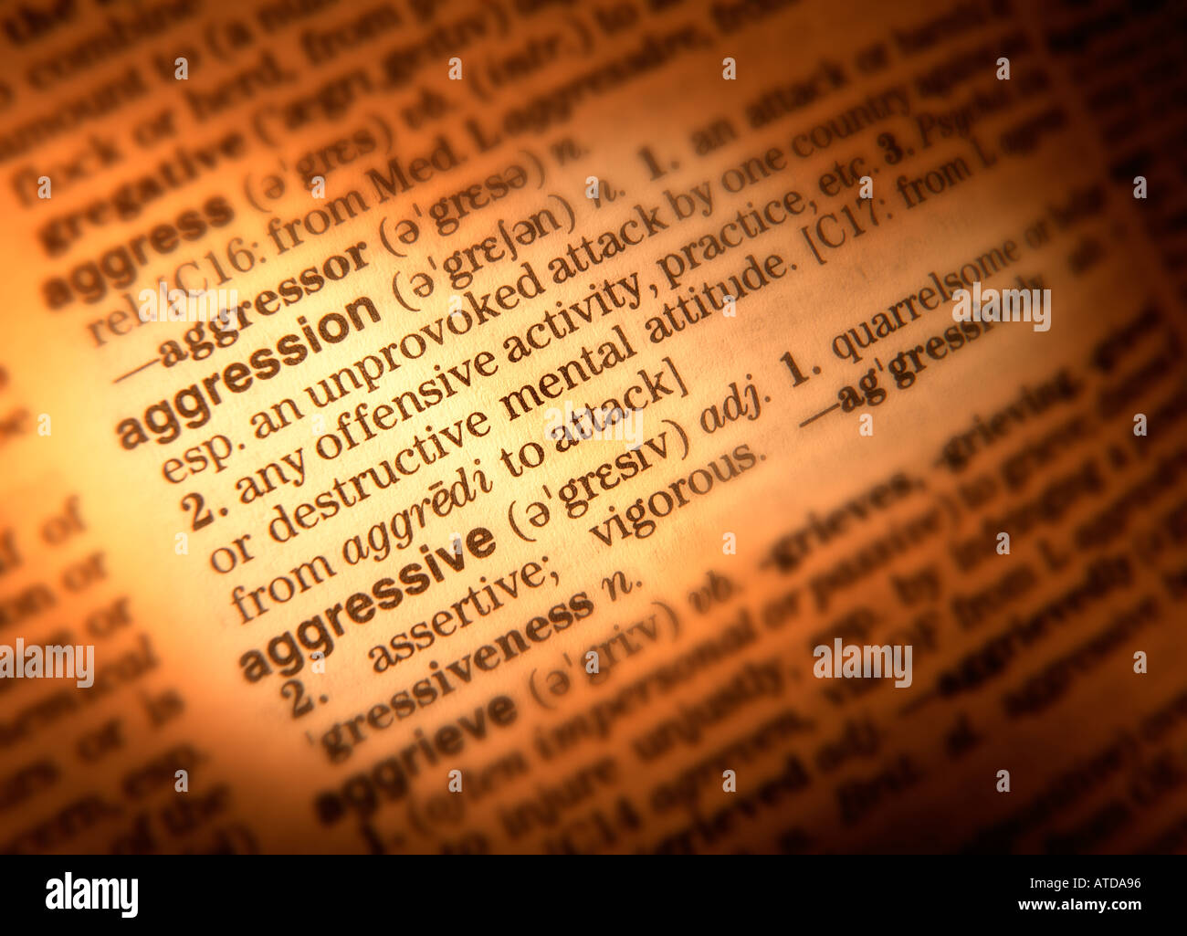 CLOSE UP OF DICTIONARY PAGE SHOWING DEFINITION OF THE WORD AGGRESSION ...
