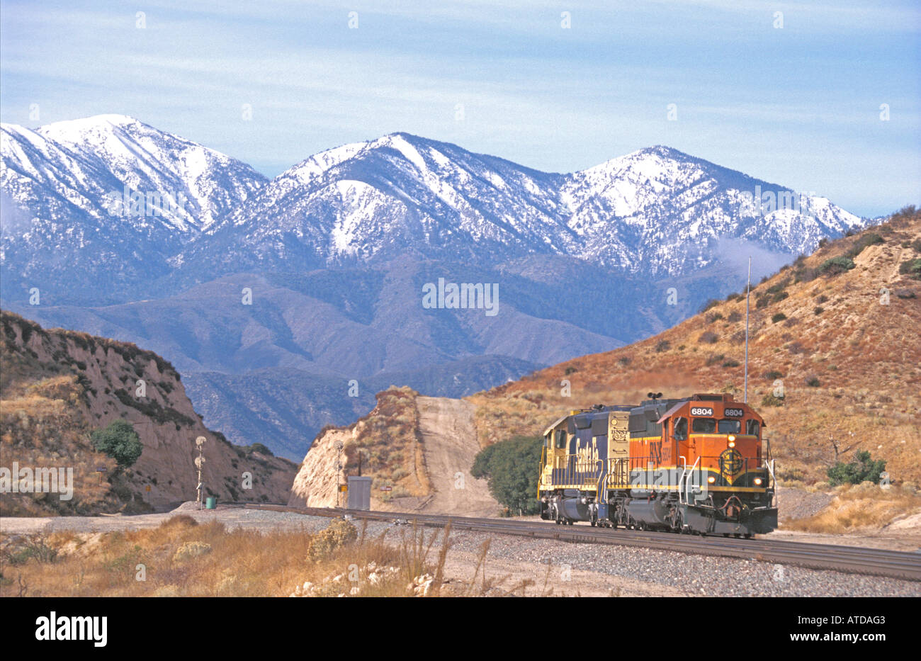 Two BNSF engines 6804 and 6364 returning light down the Cajon Pass in southern California Stock ...