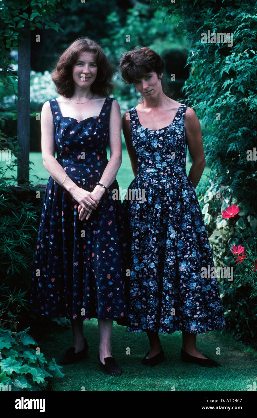 Two English sisters in their thirties in similar long floral dresses ...