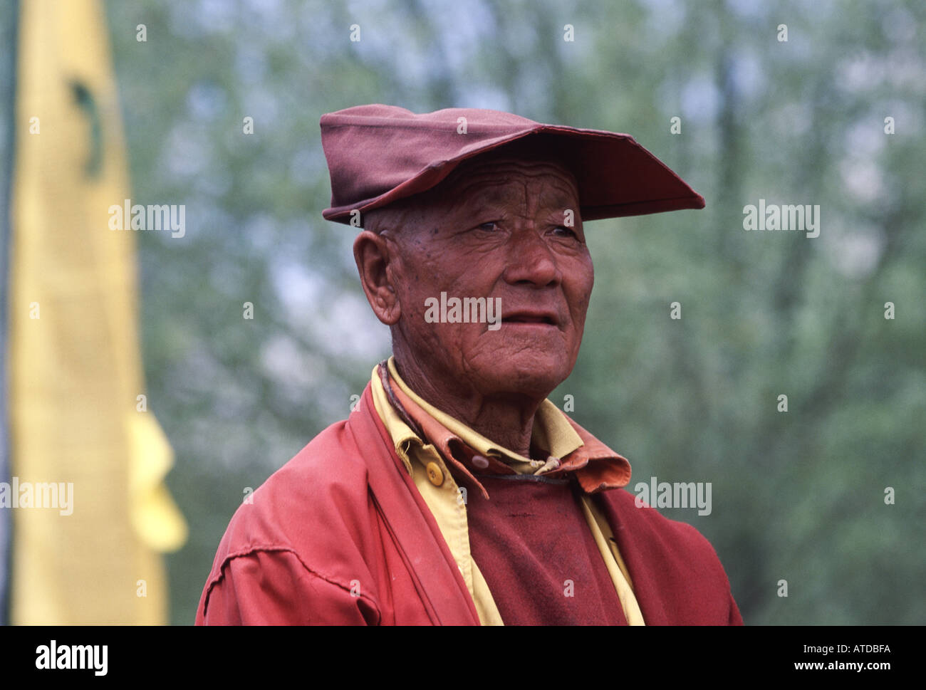 Tibetan Buddhist Monk with selfmade hat for sun protection at the Dalai ...