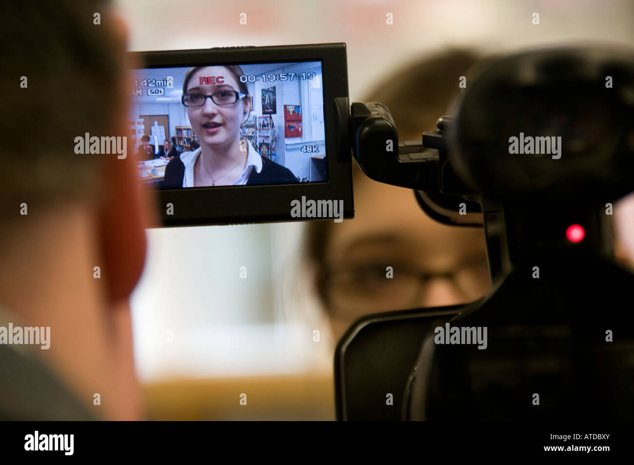 sixth form girl school pupil being filmed on video camera as part of ...