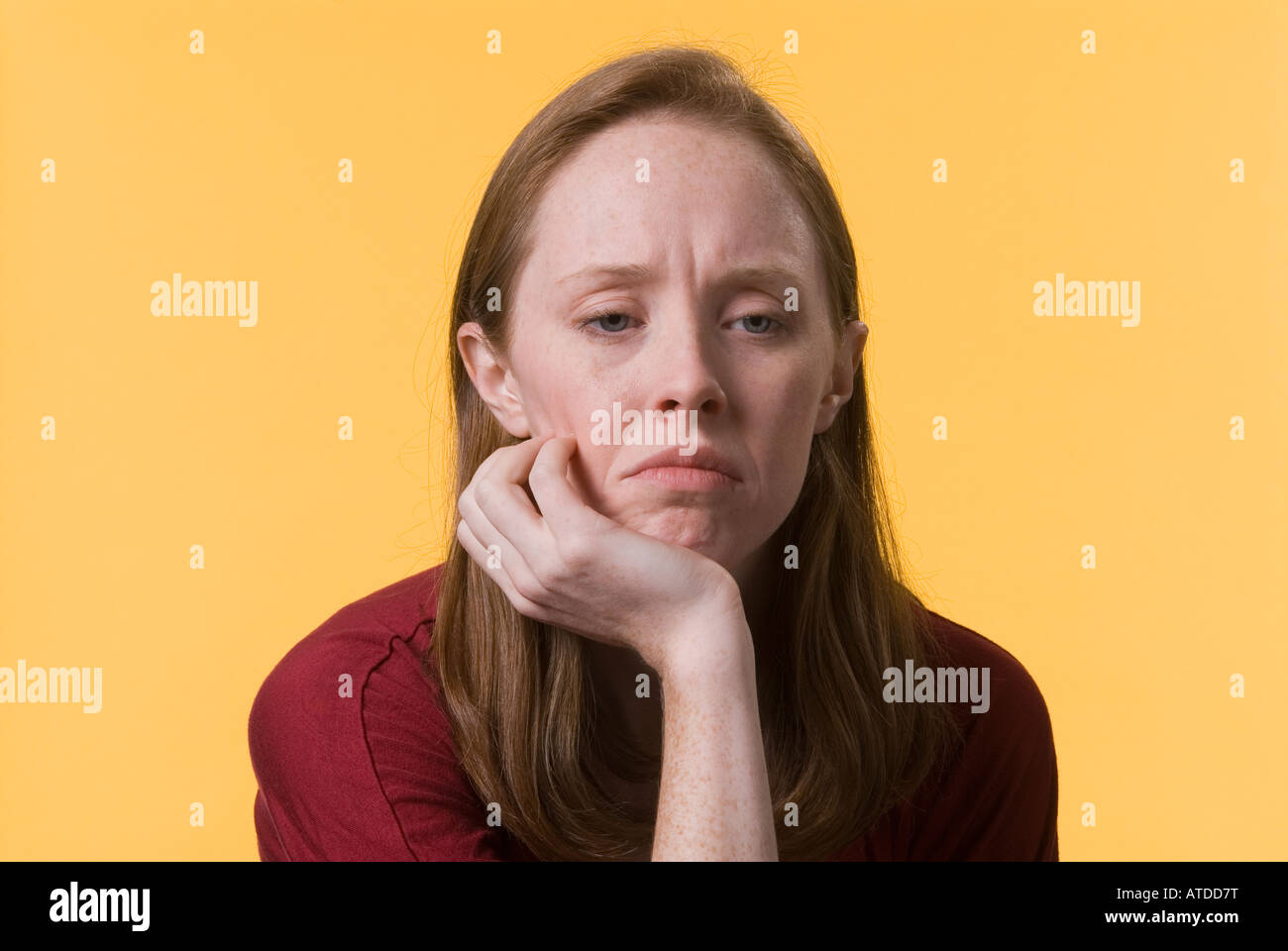 a sad depressed young woman with her hand on her chin Stock Photo - Alamy