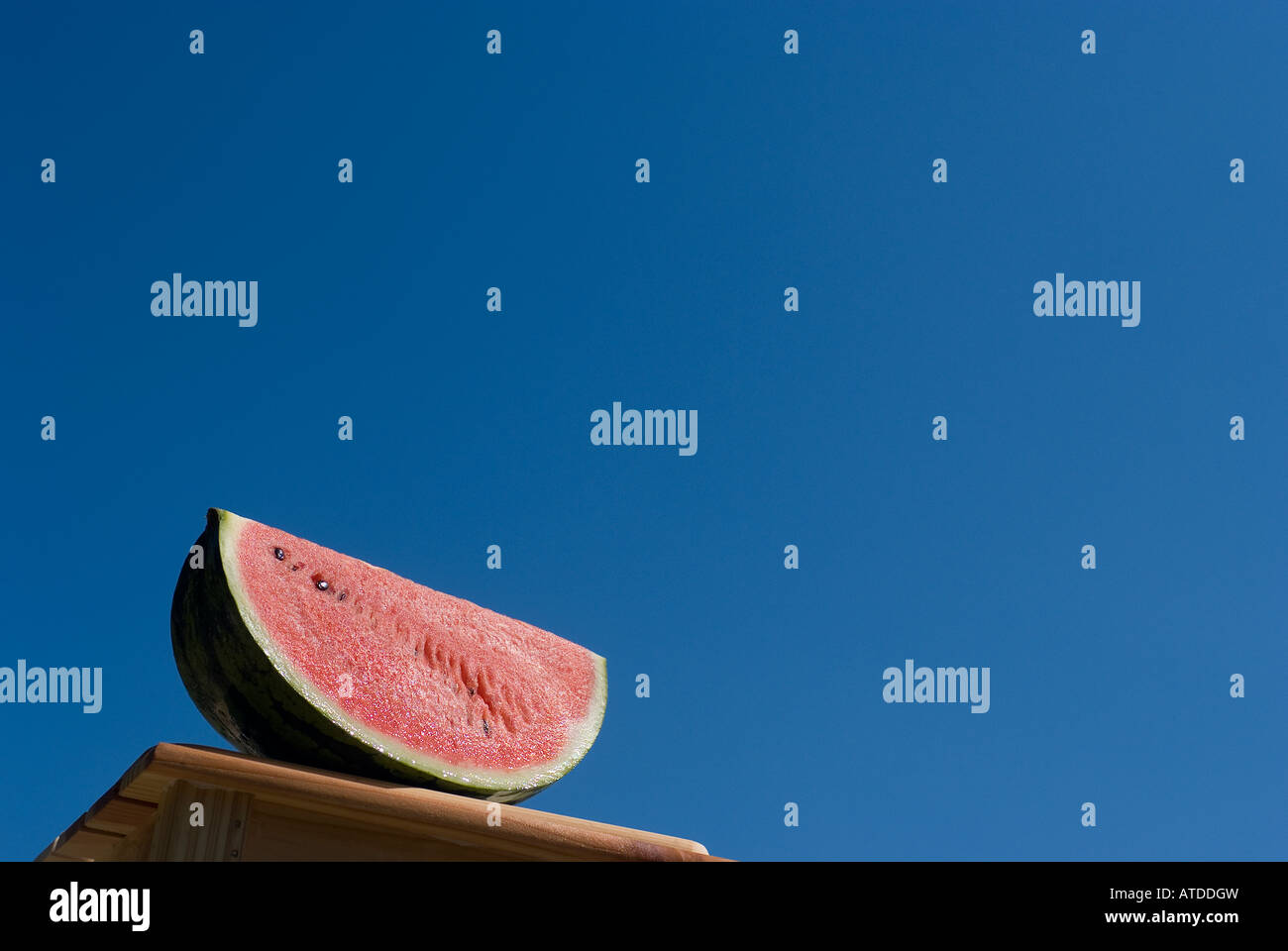 Slice of watermelon against blue sky Stock Photo - Alamy
