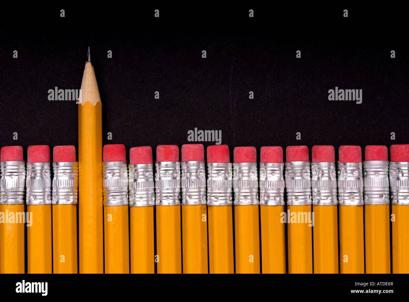 A sharp pencil amid a number of pencils eraser end up Stock Photo - Alamy