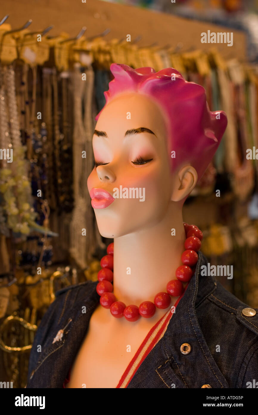 window dummy with pink hair and red necklace and dark jacket Stock ...
