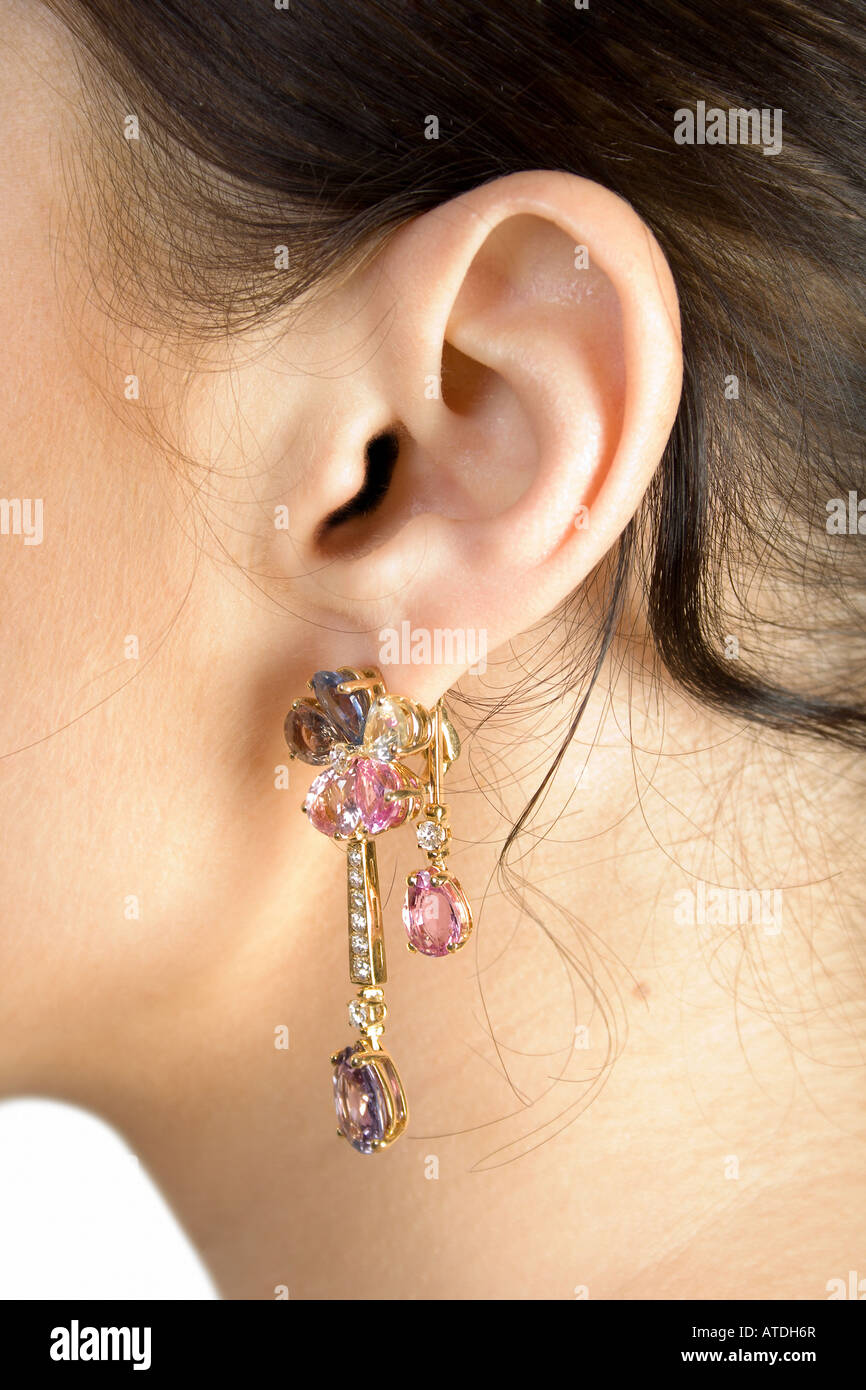 Brunette girl ear with jewelry Stock Photo - Alamy