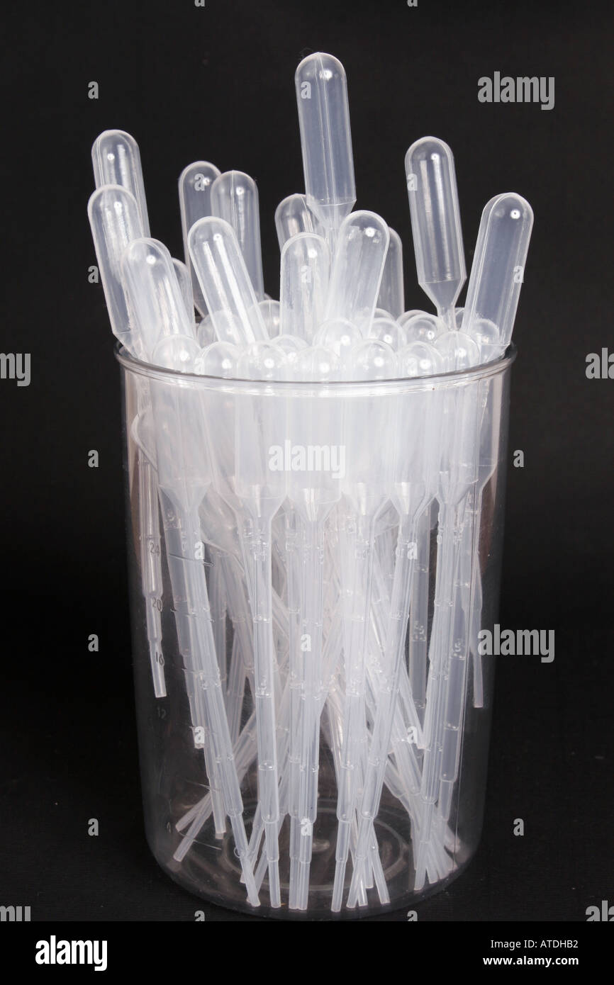 Pipettes in glass jar on black background Stock Photo - Alamy