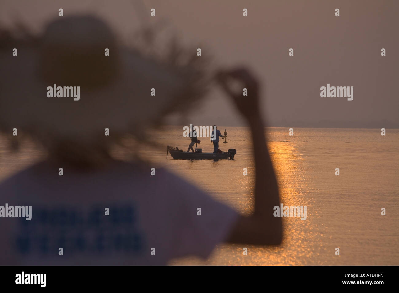 Young woman looking at boat on lake Stock Photo - Alamy