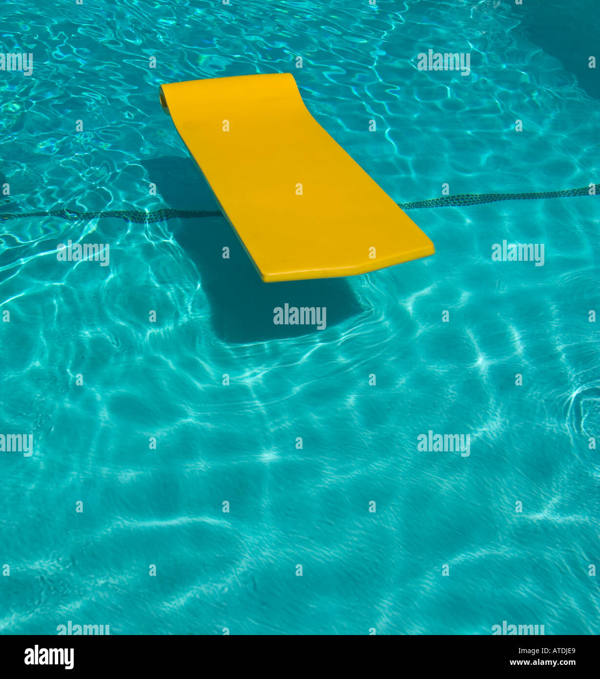Yellow float in swimming pool Stock Photo - Alamy