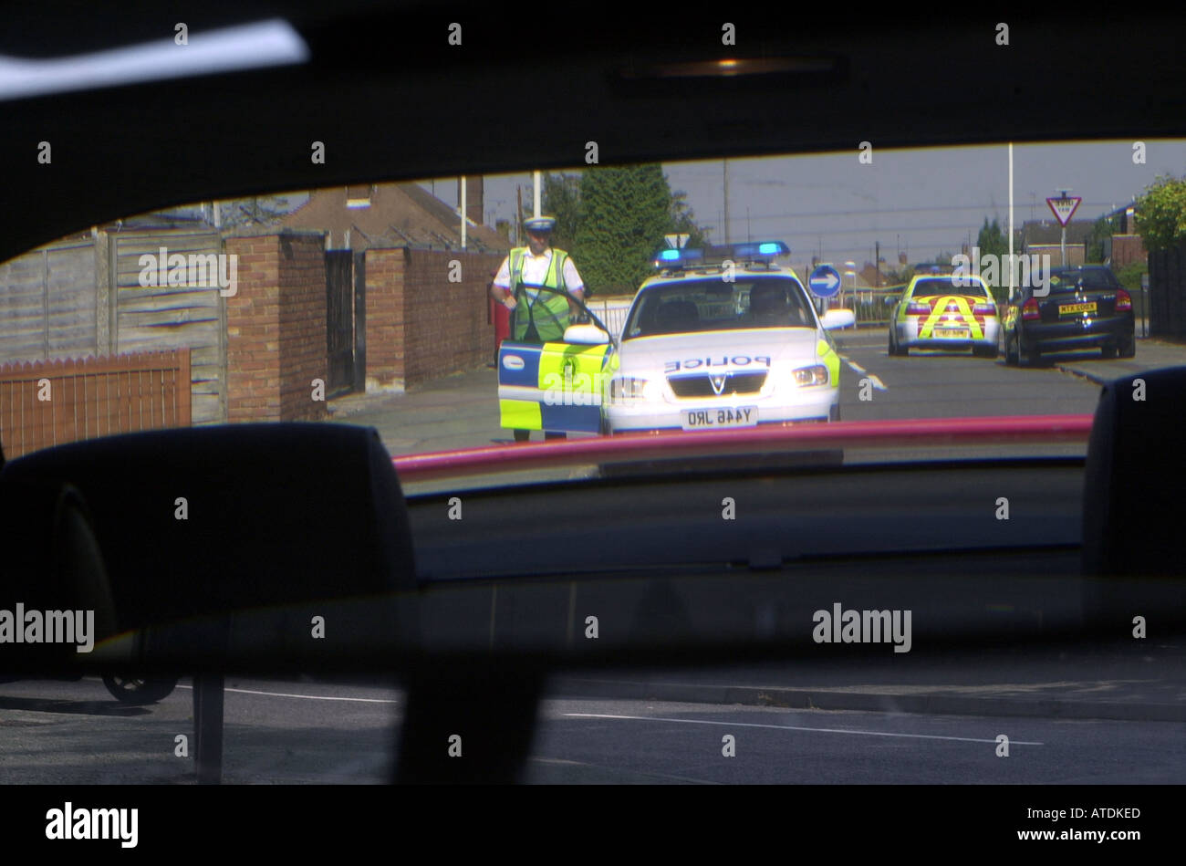 Traffic police through the rear view mirror of a car that they have ...