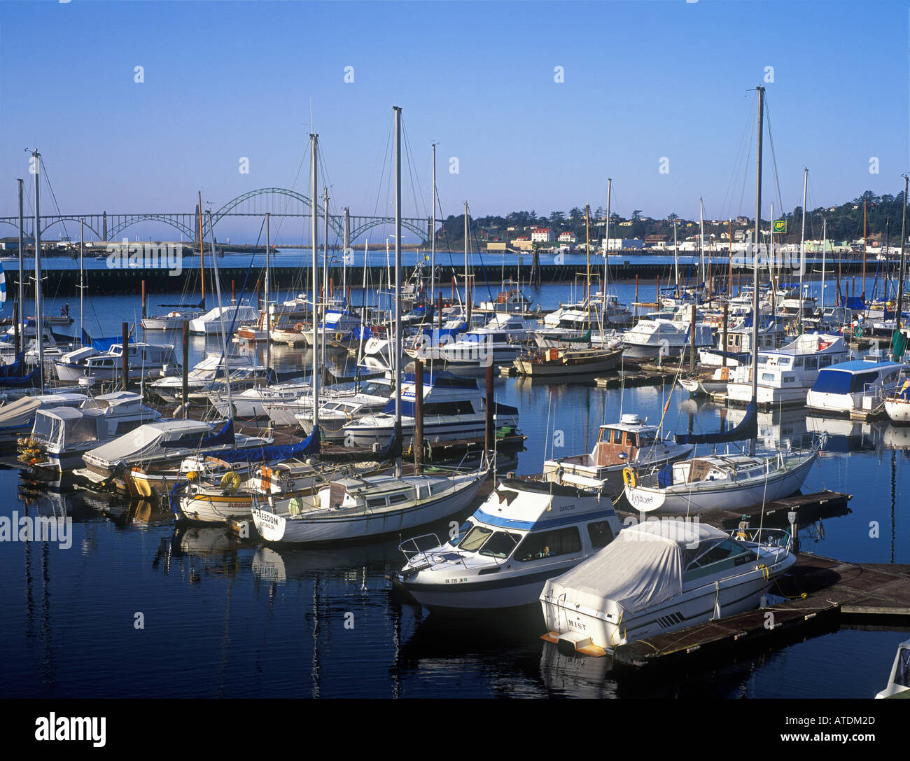 Boats at Embarcadero Marina docks historic Yaquina Bay Bridge behind ...