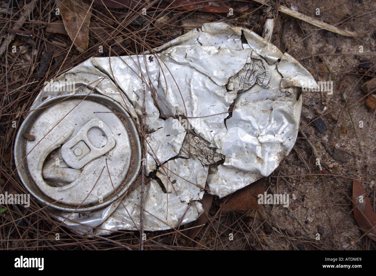 SQUASHED ALUMINIUM CAN IN DIRT Stock Photo - Alamy