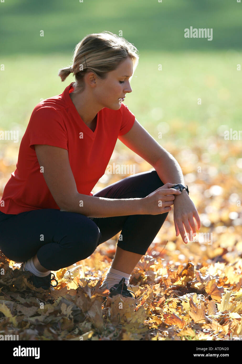 young woman resting after exercise to check pulse Stock Photo - Alamy