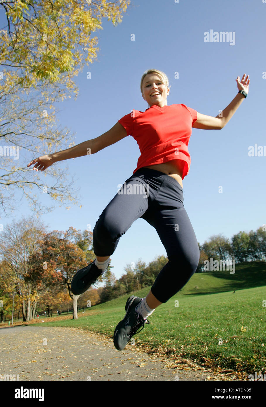 Athletic woman mid high jump hi-res stock photography and images - Alamy