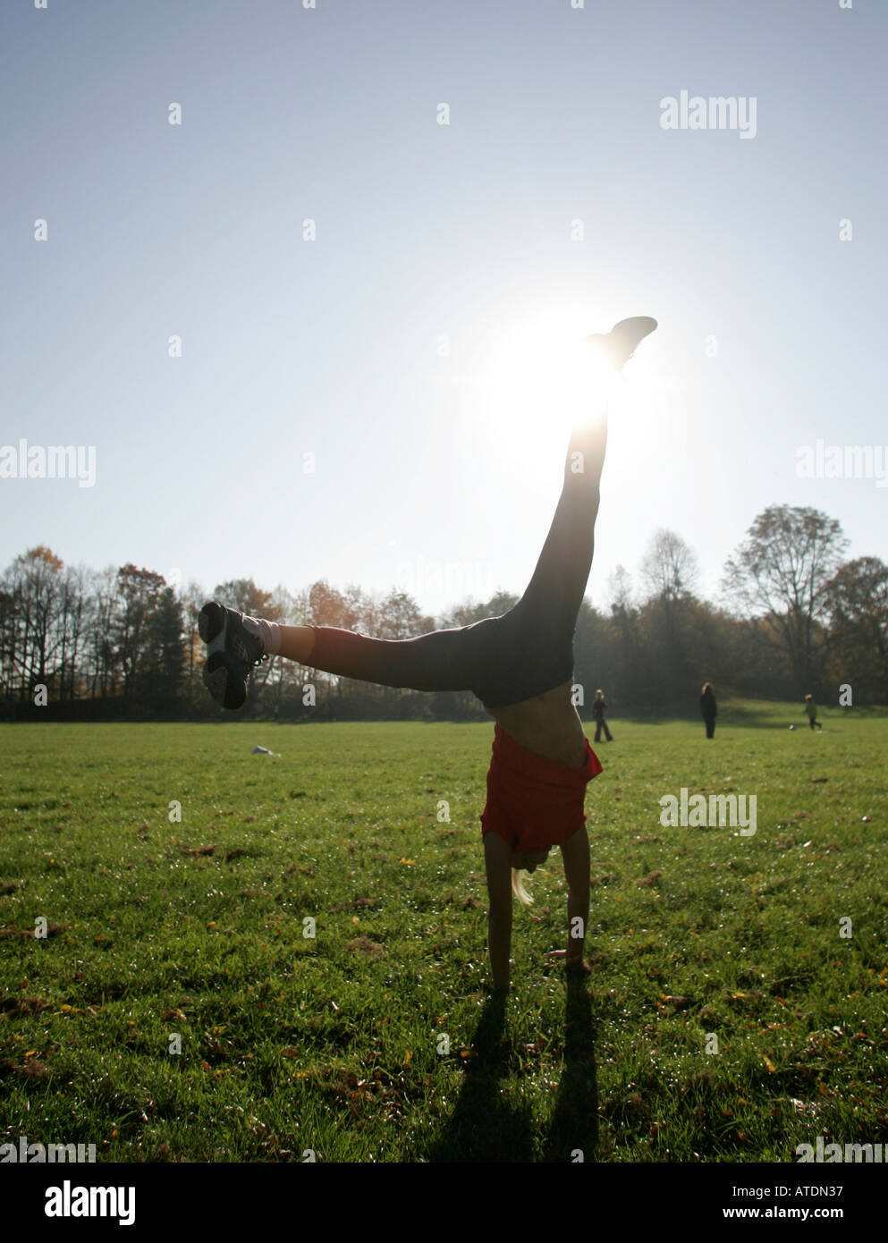 Silhouette of a young woman cartwheeling in the park Stock Photo - Alamy