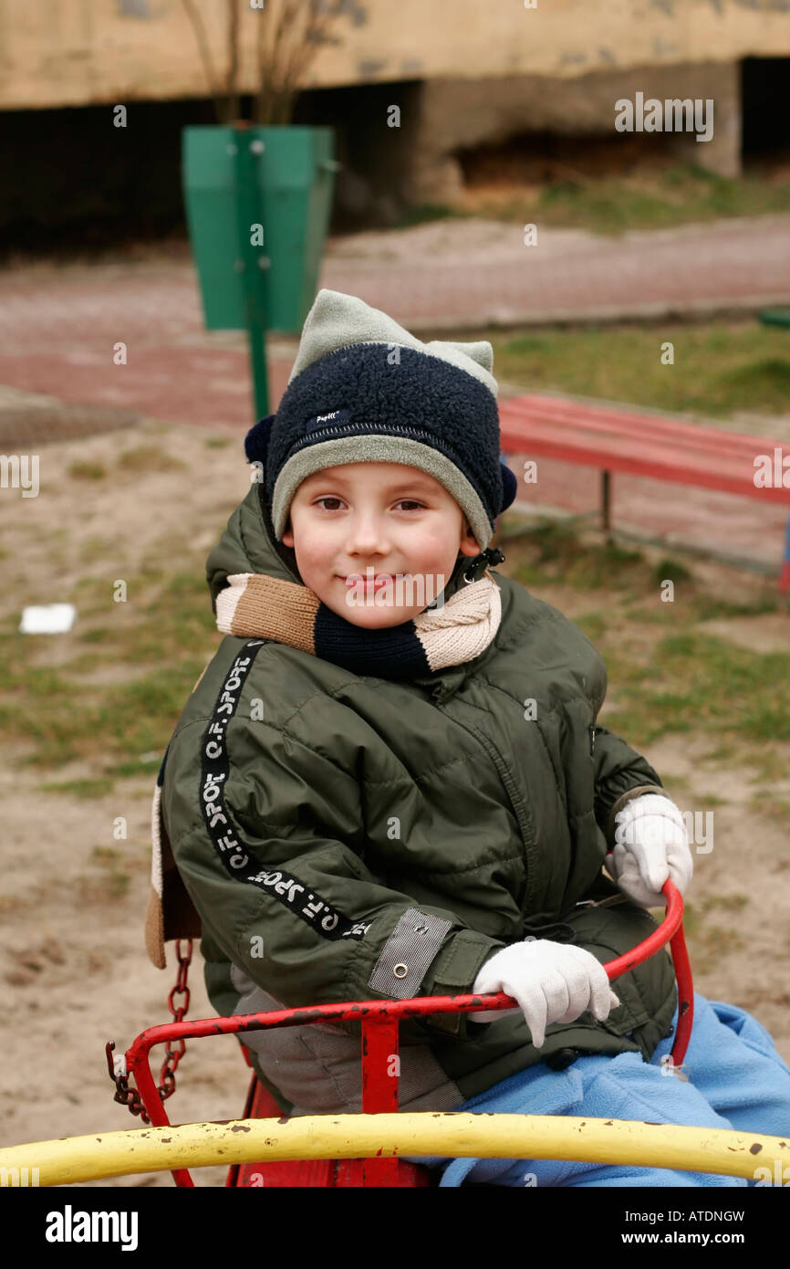 Children Playing on Merry-go-round in park Stock Photo - Alamy