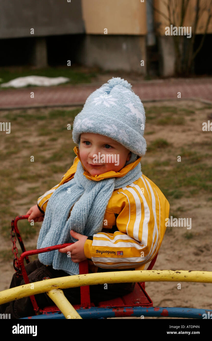 Children Playing on Merry-go-round in park Stock Photo - Alamy