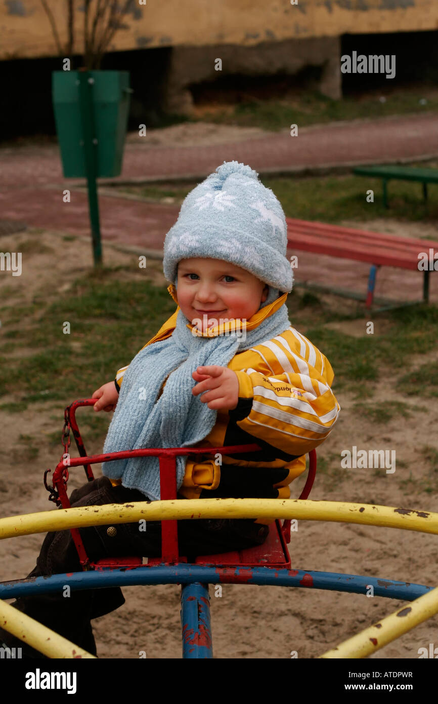 Children Playing on Merry-go-round in park Stock Photo - Alamy