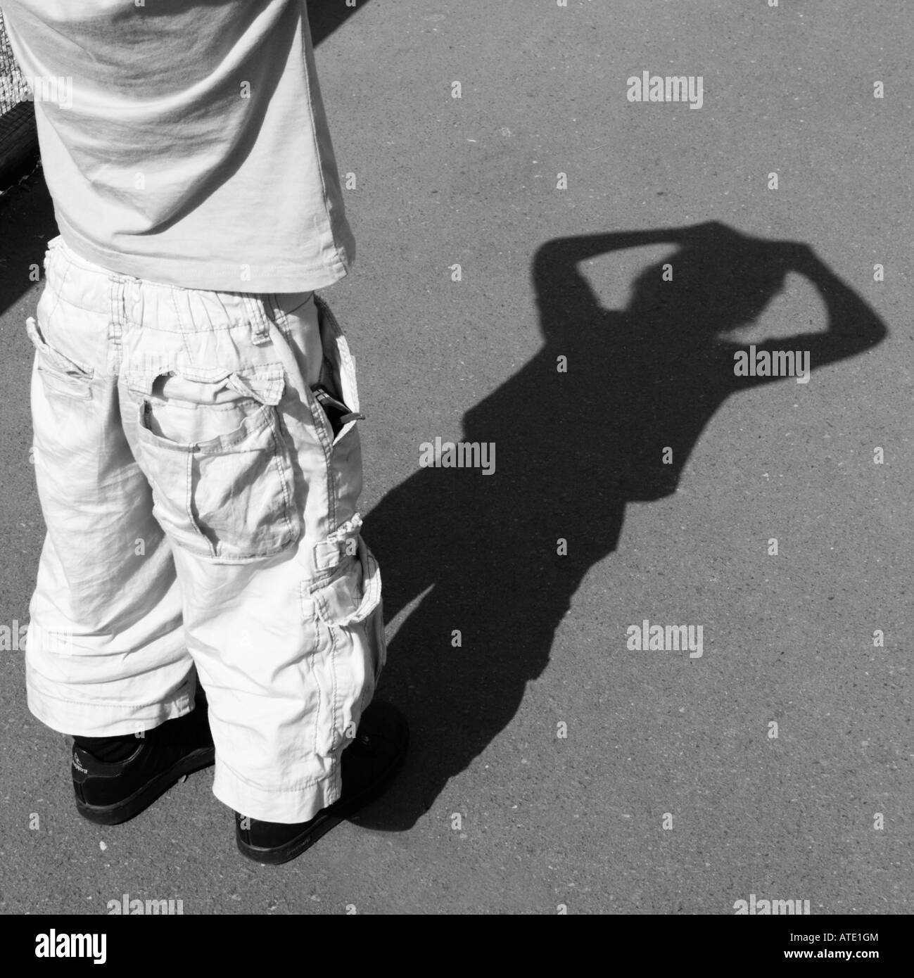 Boy casting a shadow making the shape of an eye Stock Photo - Alamy