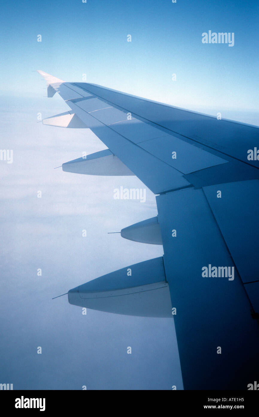 PORTRAIT VIEW FROM AEROPLANE IN FLIGHT SHOWING THE WING AGAINST A BLUE ...