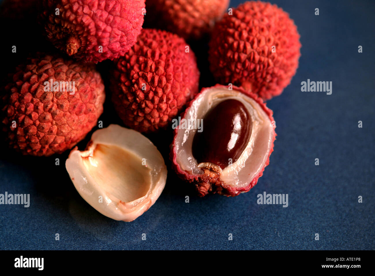 Lychees whole and halved showing the stone and flesh Stock Photo - Alamy