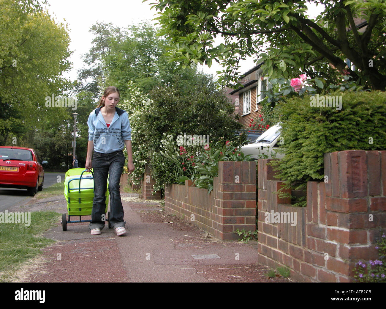 teenage girl delivering newspapers on a paper round Stock Photo - Alamy