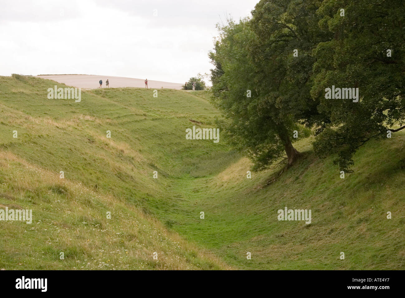 The moat earth mound surrounding Avebury stone circle Wiltshire UK ...