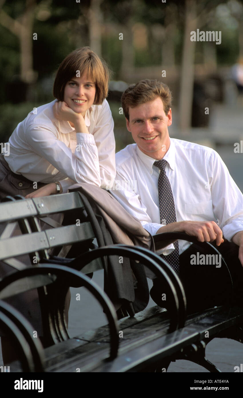 Man sitting on bench woman leaning on bench Stock Photo - Alamy