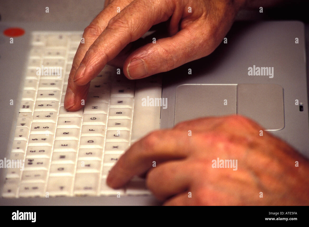 68 year old man using computer keyboard London England Stock Photo - Alamy