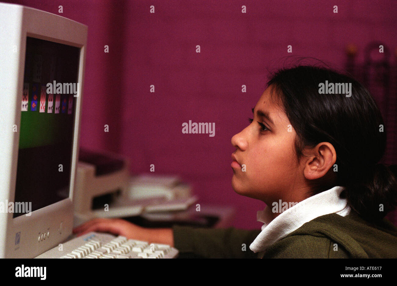 Young girl at after school club using computer facilities Bethnal Green ...