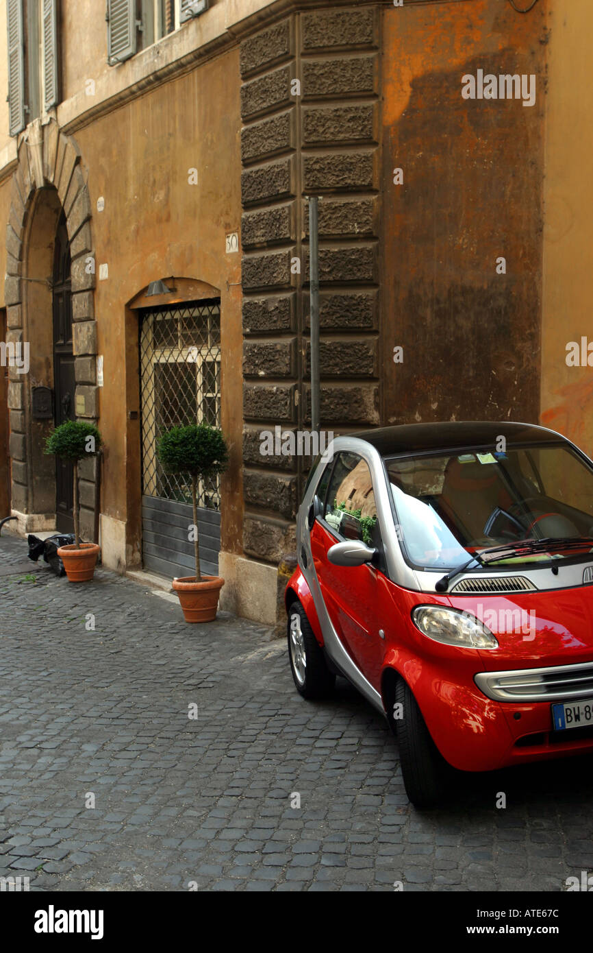 Smart car parked in an old street in Rome Italy Stock Photo - Alamy