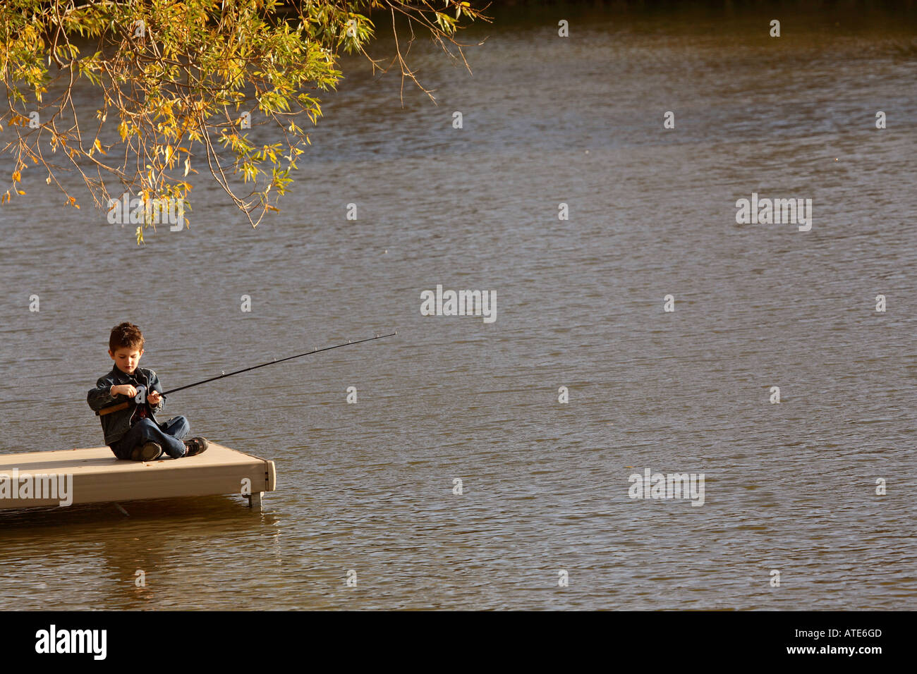 Boy fishing off dock in hi-res stock photography and images - Alamy