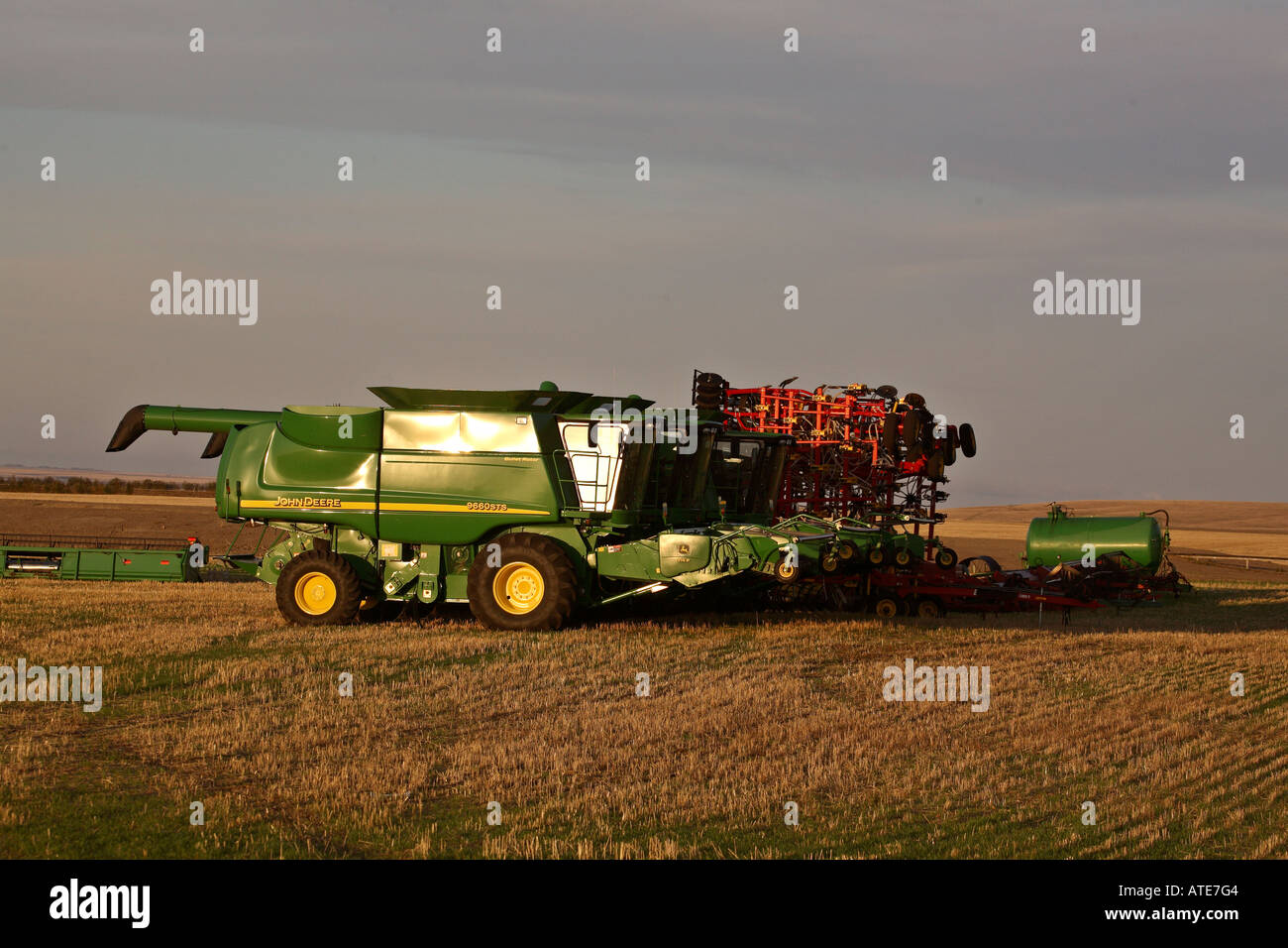 Combines neatly lined up in scenic Saskatchewan Canada Stock Photo - Alamy