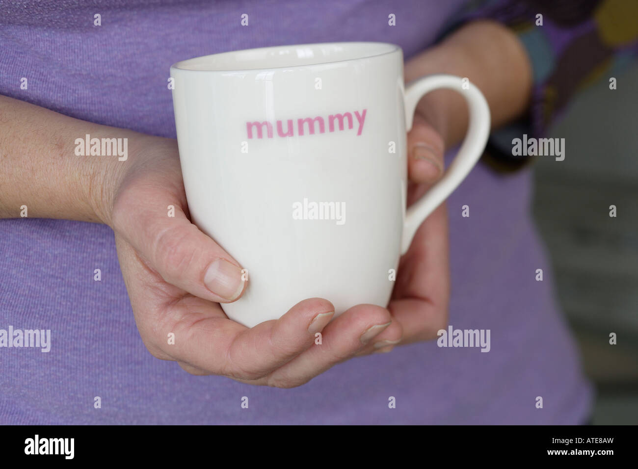 Mummy mug being cupped by Mum Stock Photo - Alamy