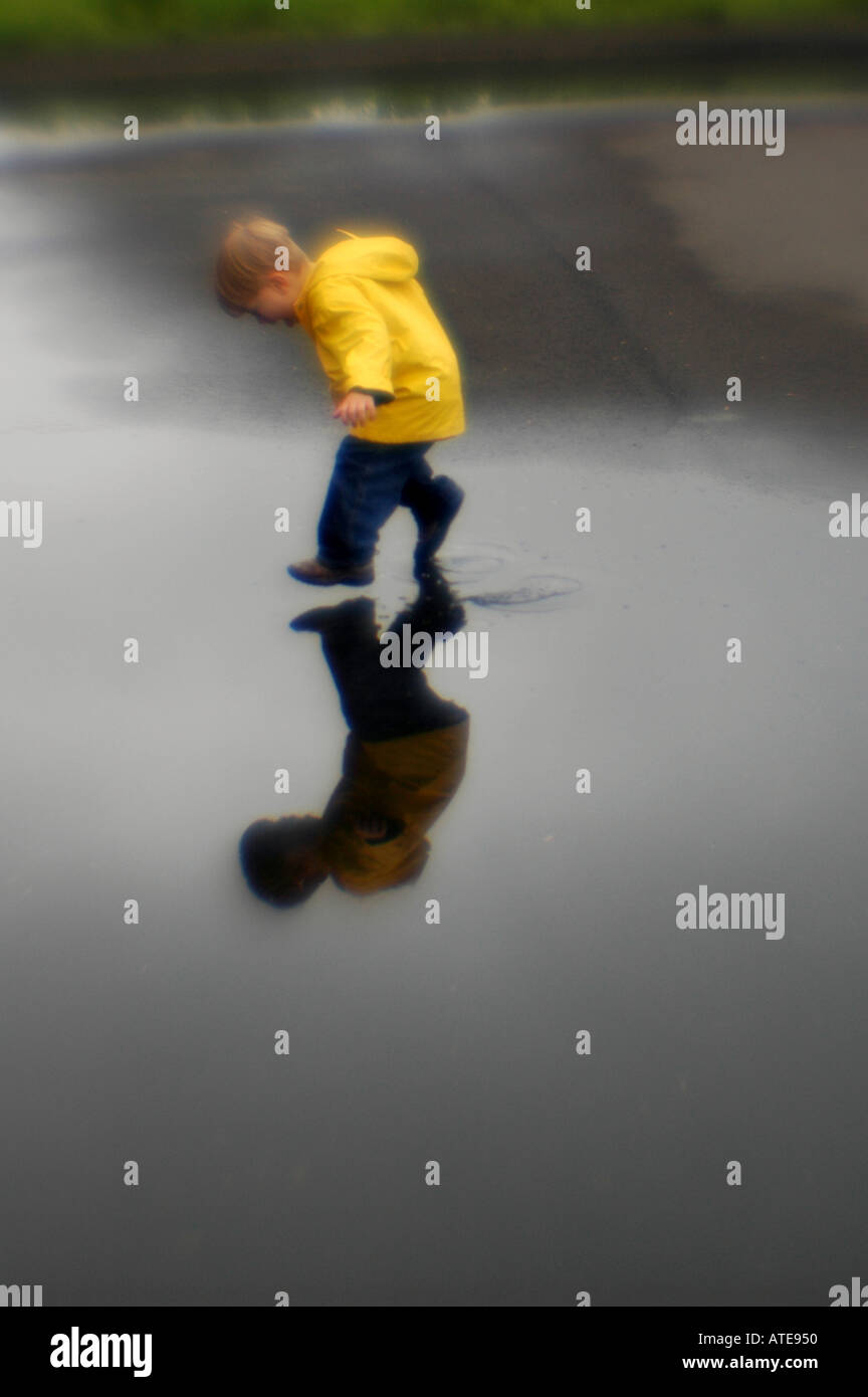 Small boy playing in puddle of water Stock Photo - Alamy