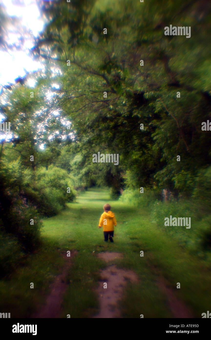 Small child walking on pathway leading away Stock Photo - Alamy