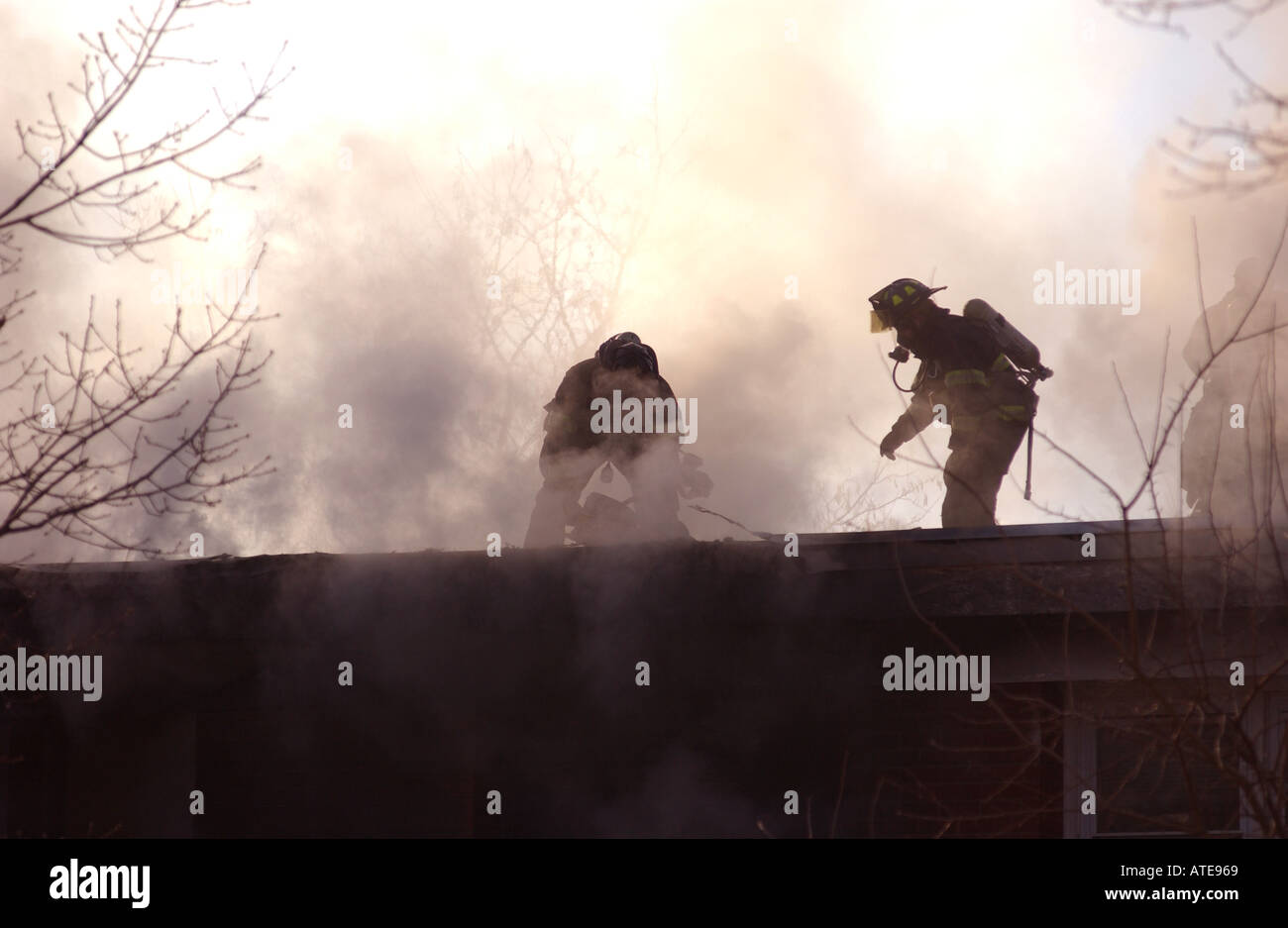 firefighters fighting smoky blaze on a roof of a home Stock Photo - Alamy