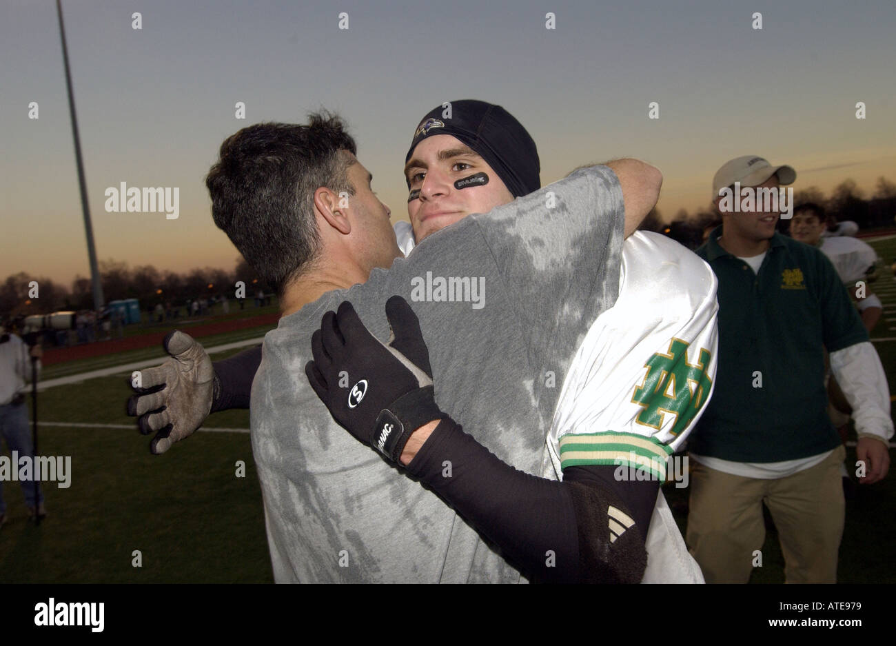 American footbal hug after high school game victory Stock Photo - Alamy