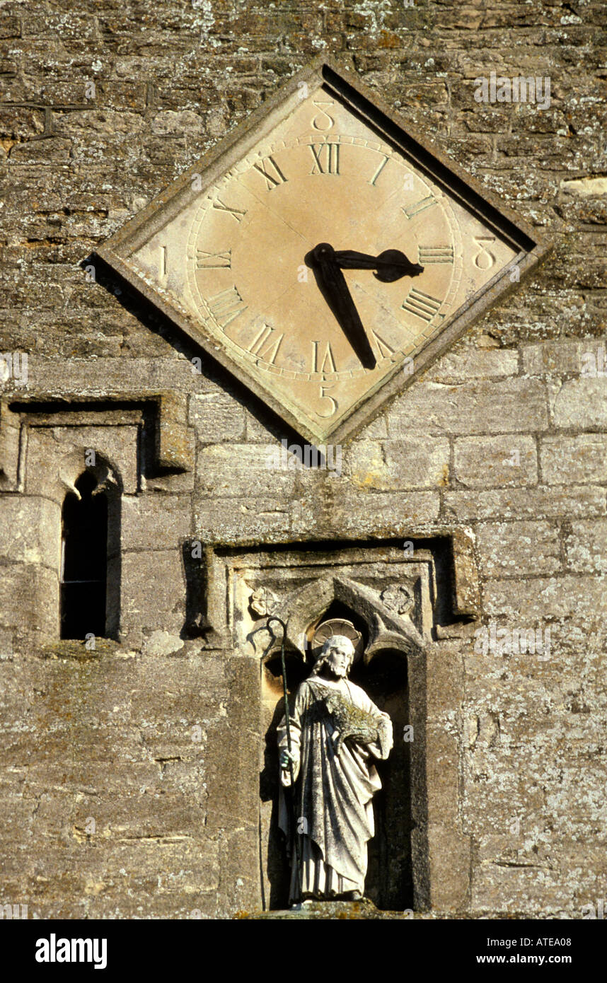 Clock face and statue on front of South Marston church Wiltshire Stock ...