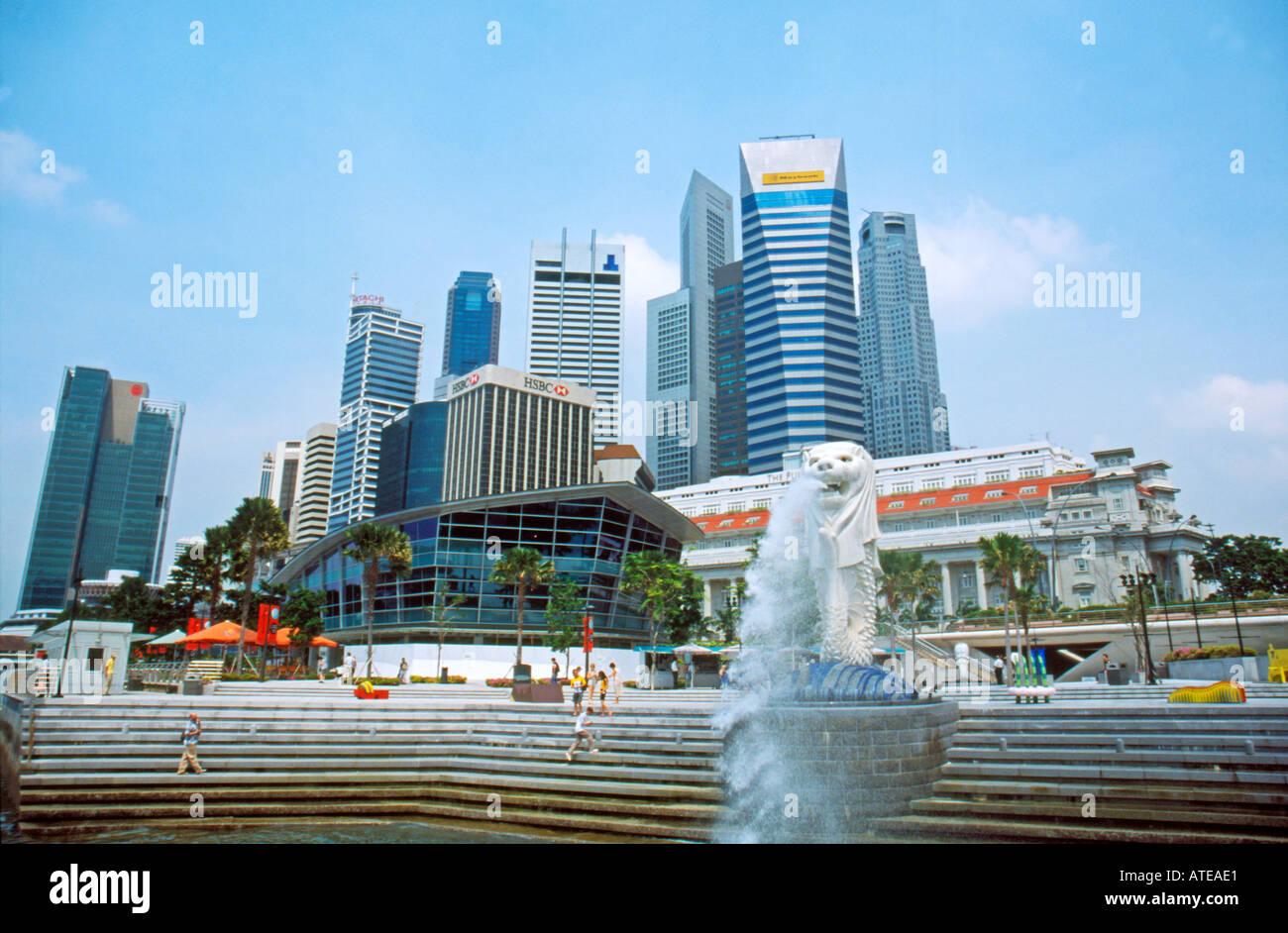 Merlion statue guards the harbour entrance with city skyline Singapore ...