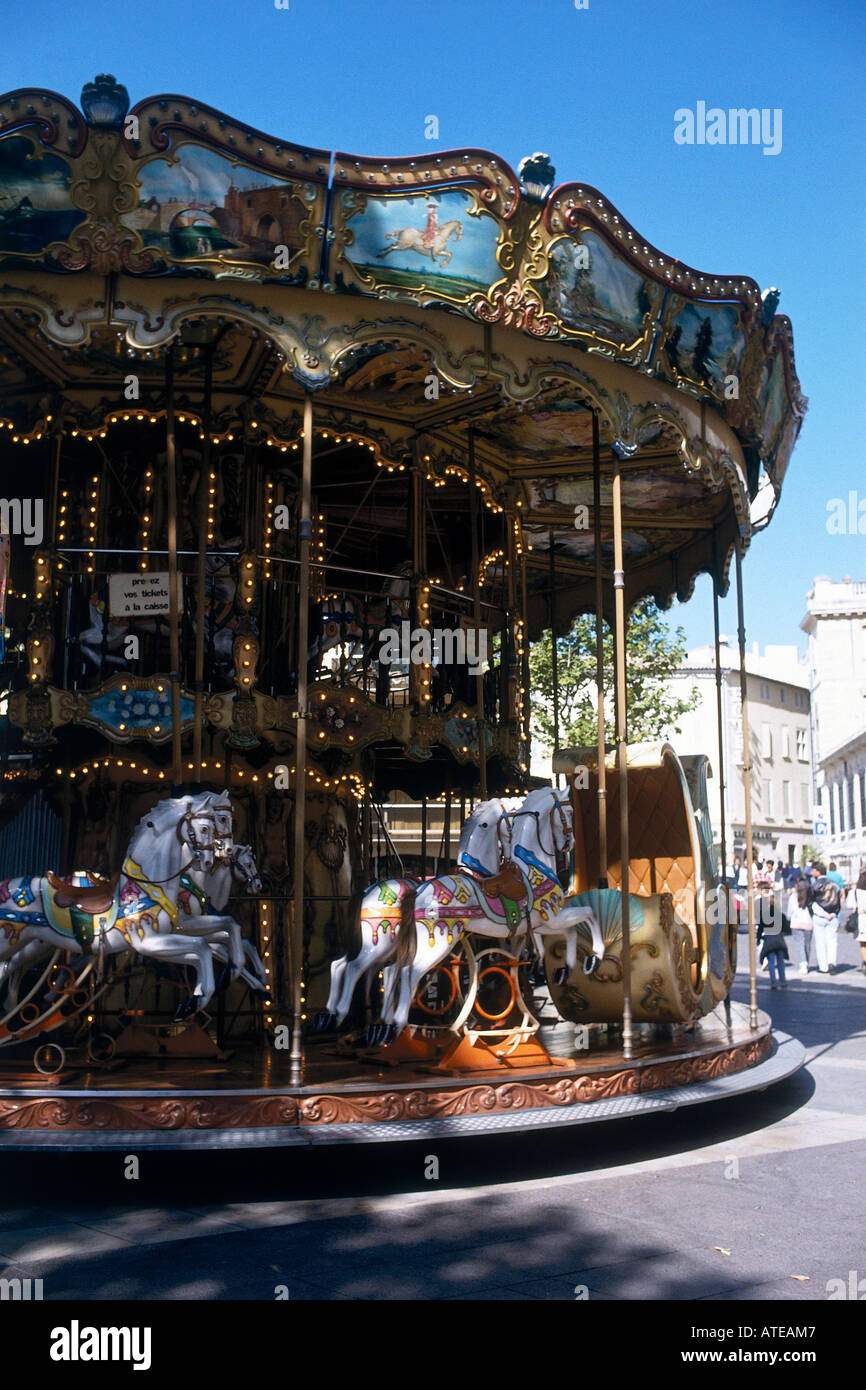 An antique carousel spinning around in the dappled sunshine before the ...