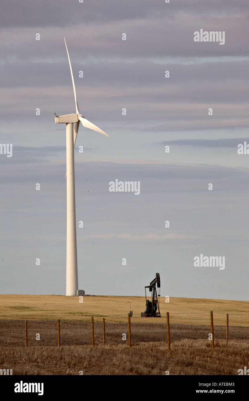 Oil pump near windmill electricity generator in Saskatchewan Canada ...