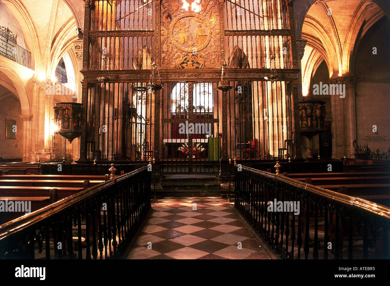 Viewed along the length of the tiled central aisle sunlight ...