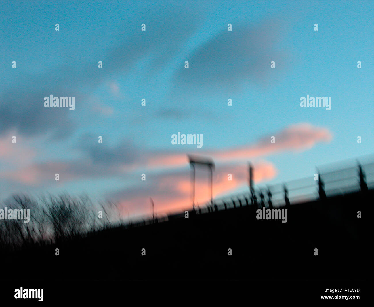 A highway overpass and road signs during dusk Stock Photo - Alamy